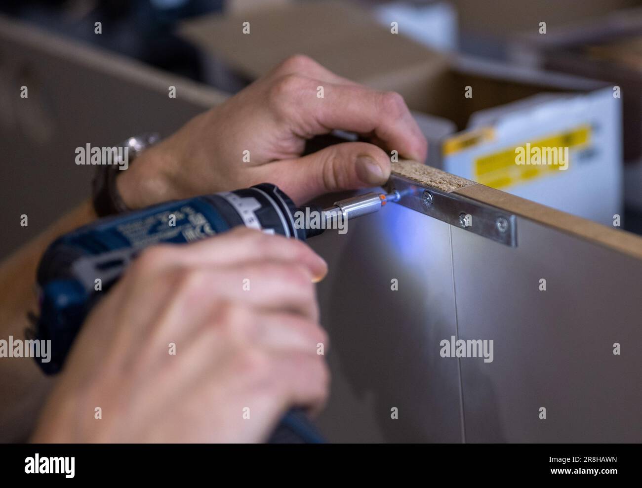 Berlin, Germany. 19th June, 2023. A craftsman screws a screw into a ...