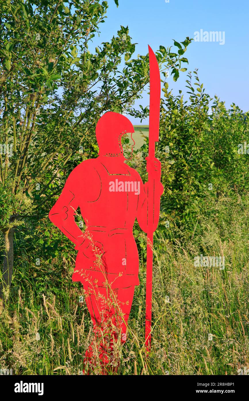 A silhouette of a medieval soldier with glaive near the battlefield of ...