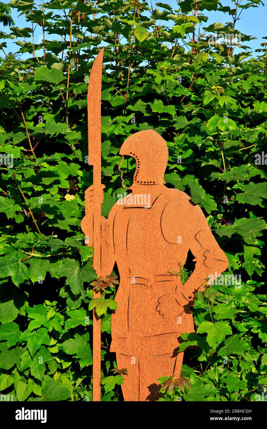A silhouette of a medieval soldier with glaive near the battlefield of ...