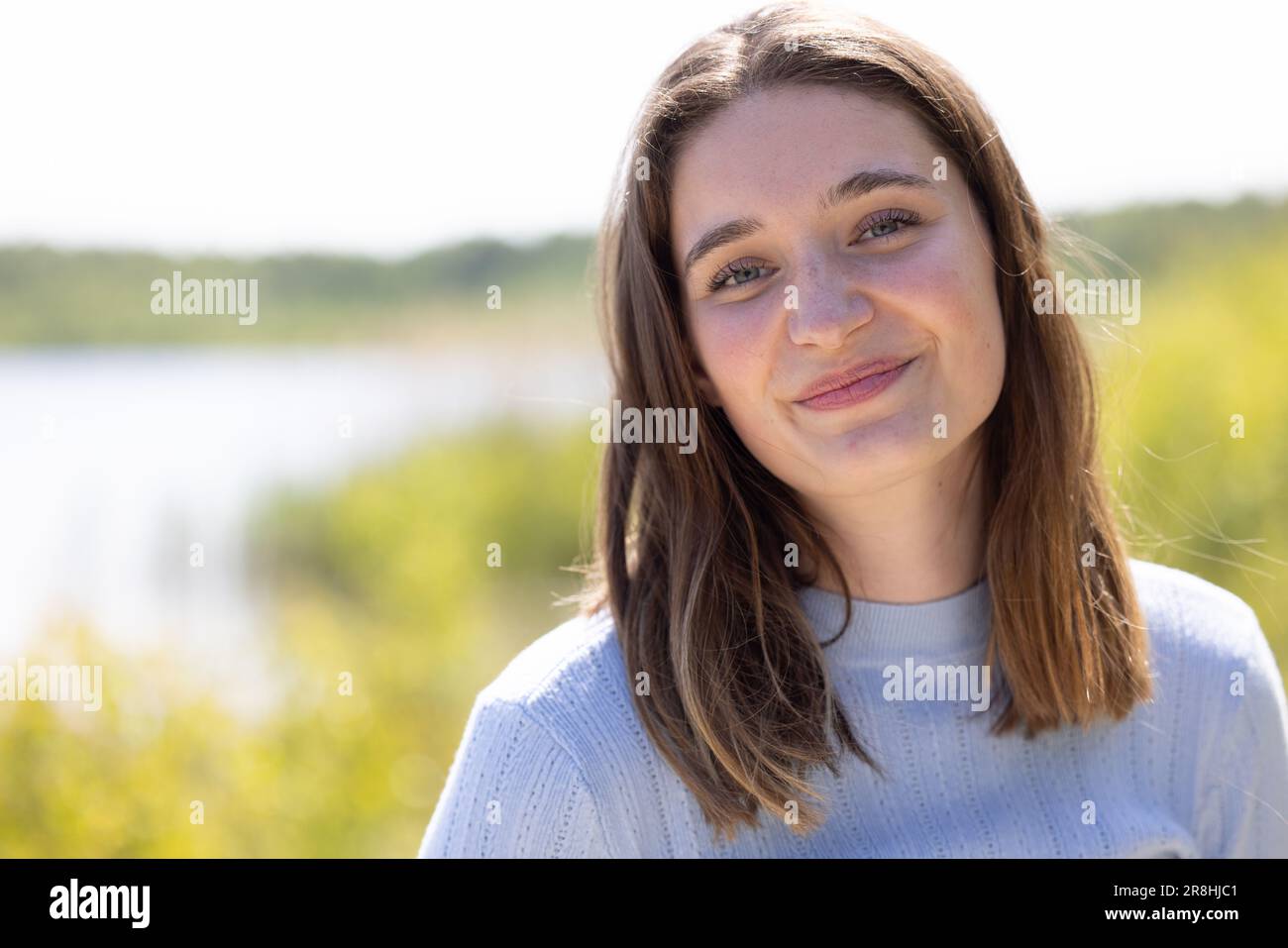 Happy beautiful girl holding her cheeks with a laugh, looking at the ...