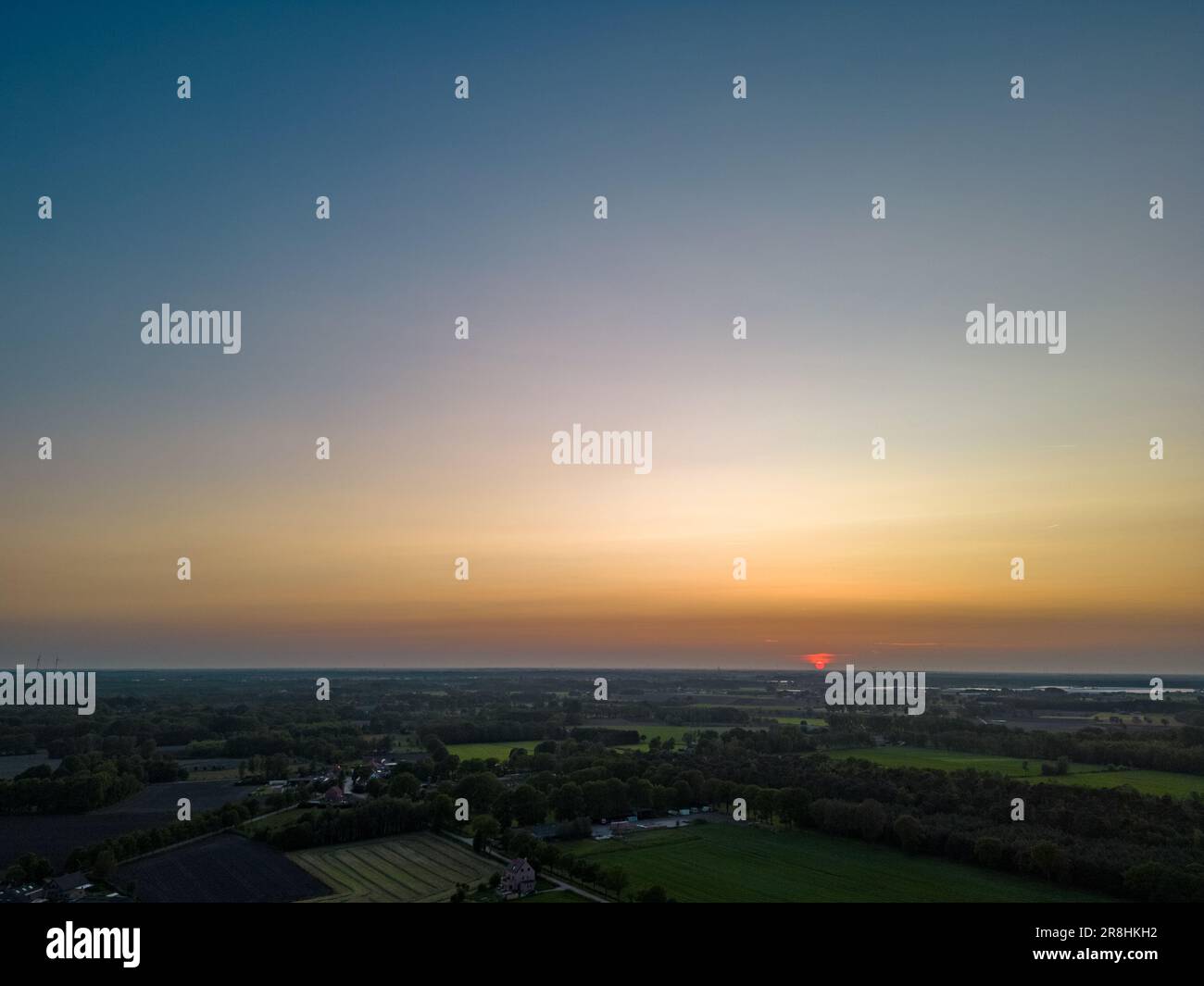 Aerial view of endless lush pastures and farmlands of Belgium under a ...