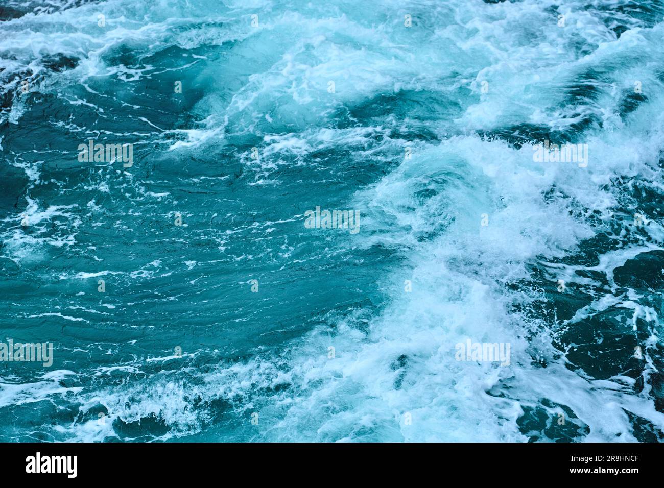 A stunning blue ocean with white-crested waves, providing a picturesque ...