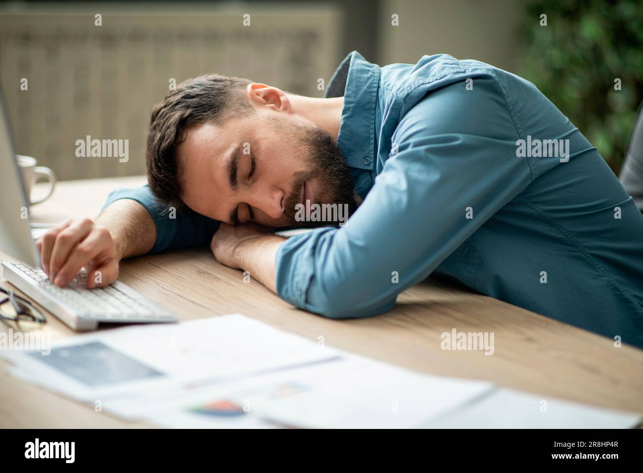 Portrait Of Tired Young Office Employee Sleeping At Workplace Stock ...