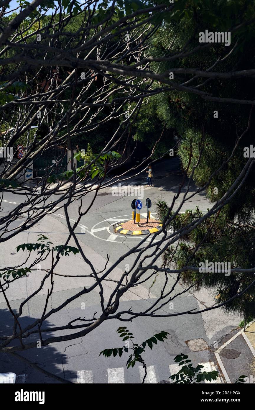 Roundabout next to a park and an elevated road seen from above in an ...