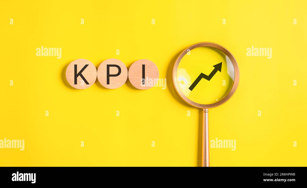 Key performance indicator, Businessman holding wooden cube with KPI ...