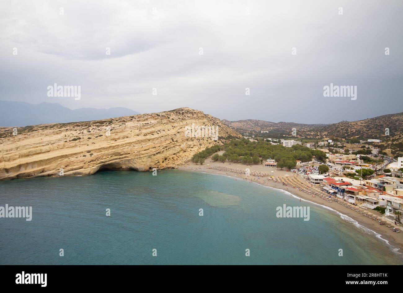 View on Matala, Crete, with beach and sea, surrounded by limestone ...
