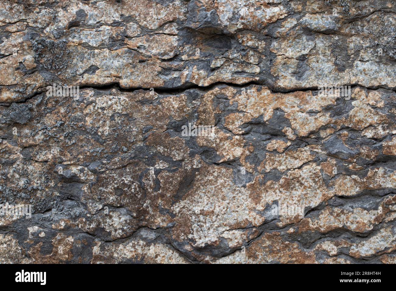Old stone dark brown wall, textured background Stock Photo - Alamy