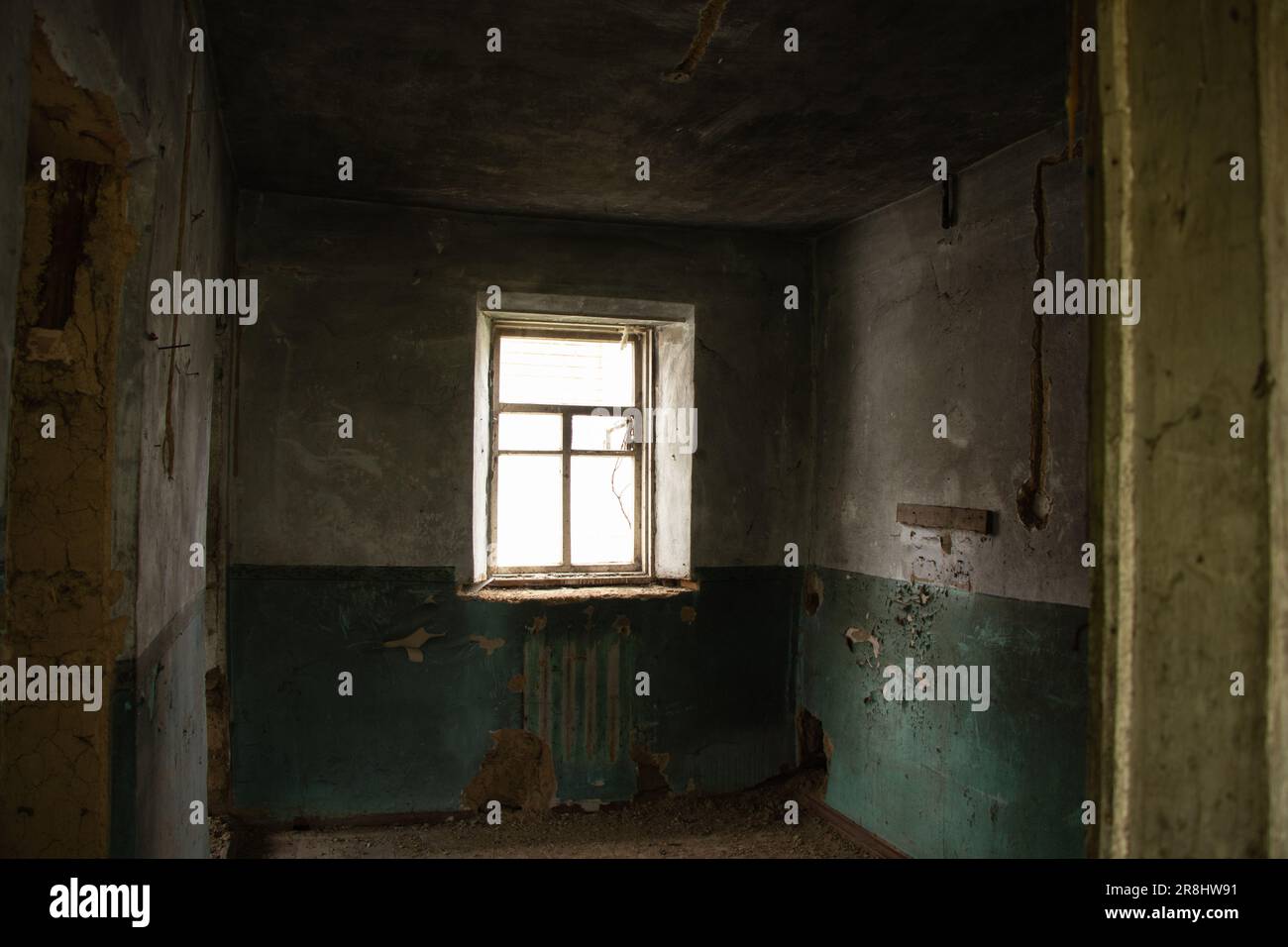 old abandoned one-story building dark without windows and doors, destroyed building in Ukraine ...