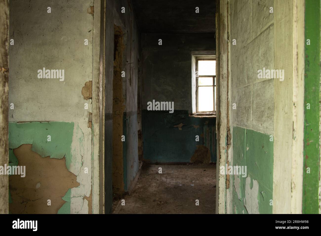 old abandoned one-story building dark without windows and doors, destroyed building in Ukraine ...