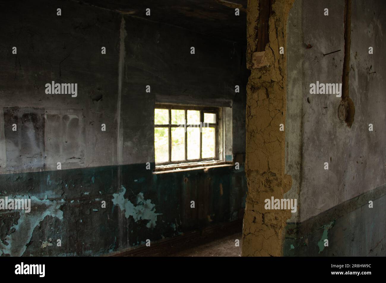 old abandoned one-story building dark without windows and doors, destroyed building in Ukraine ...