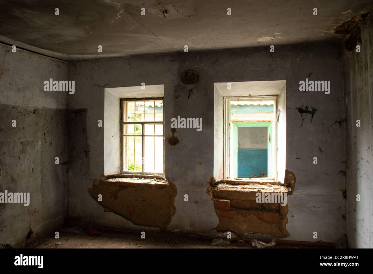 old abandoned one-story building dark without windows and doors, destroyed building in Ukraine ...