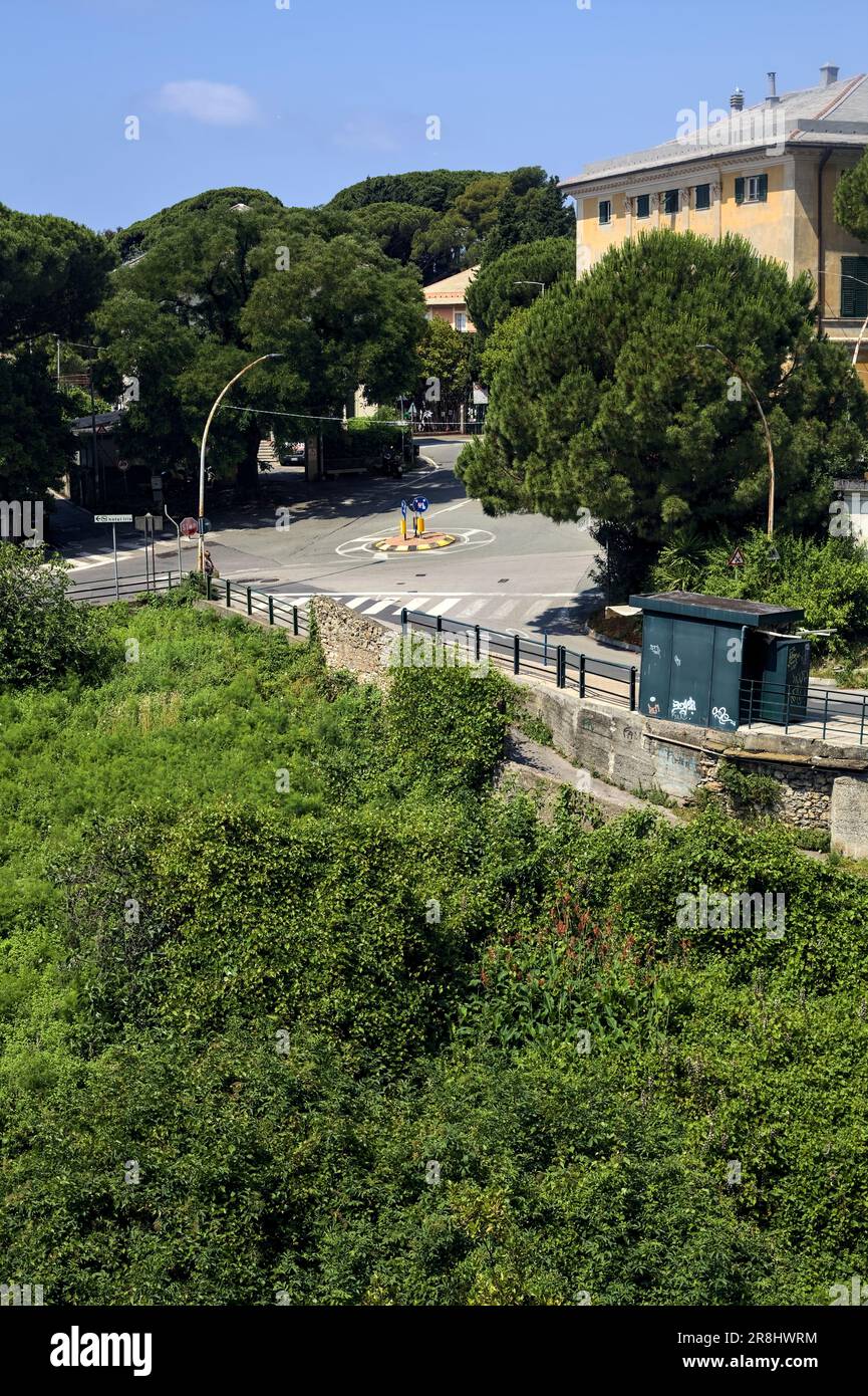 Roundabout next to a park and an elevated road seen from above in an ...