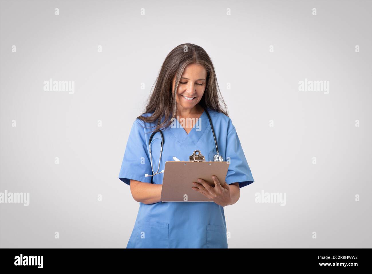 Happy senior female doc reviewing patient's medical history and taking ...