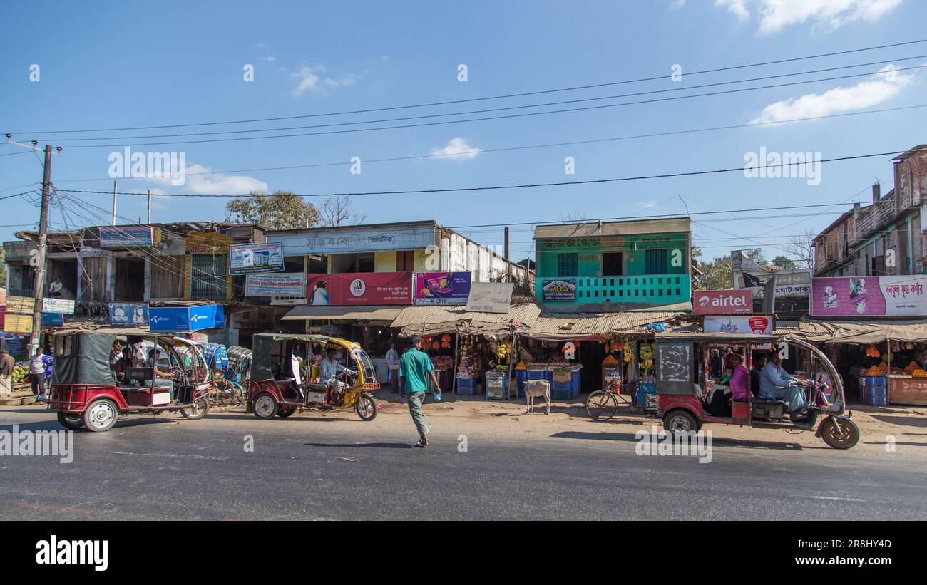 A cluster of traditional rickshaws parked in a bustling urban street ...