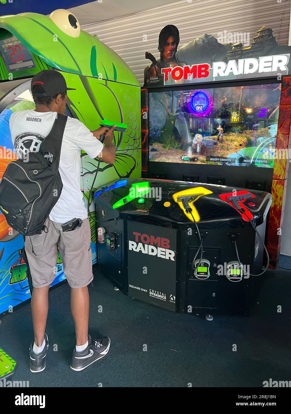 Man plays violent video game at an arcade at COney Island at the beach ...