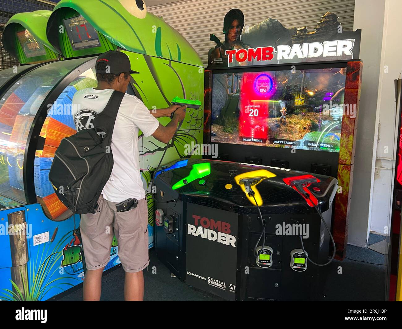 Man plays violent video game at an arcade at COney Island at the beach ...