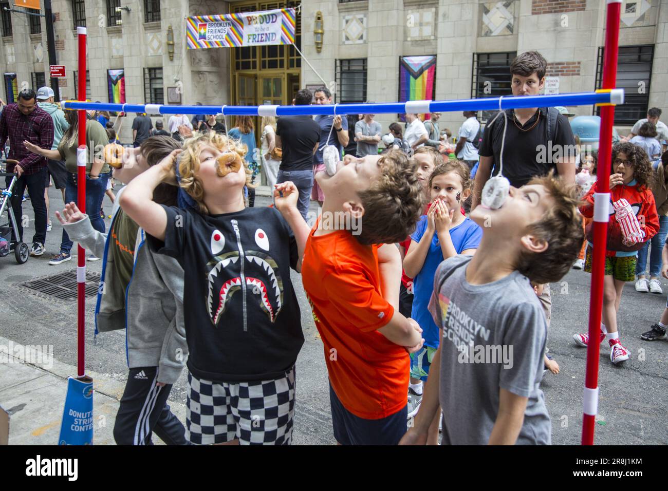Boys participate in a donut eating contest at the Friends School Fair ...