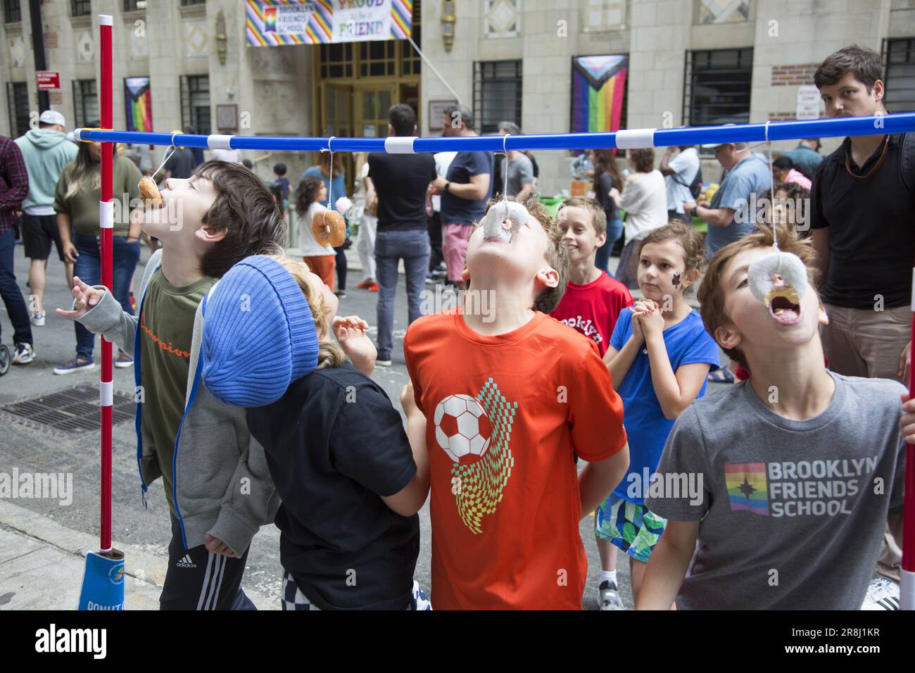 Boys participate in a donut eating contest at the Friends School Fair ...