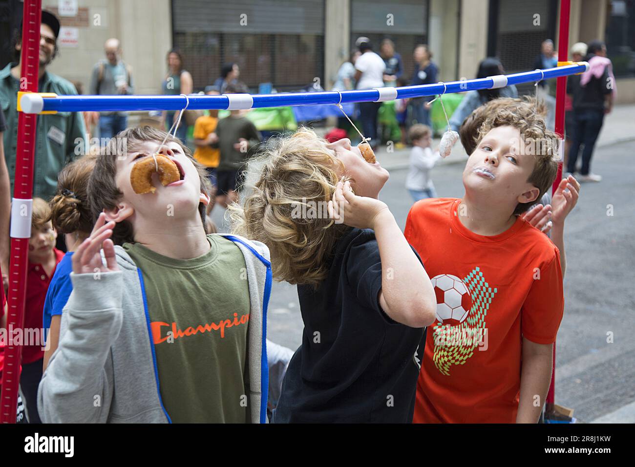 Boys participate in a donut eating contest at the Friends School Fair ...