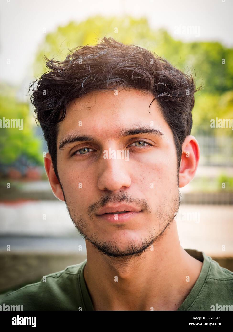 Head And Shoulder Shot Of One Handsome Young Man In Urban Setting Stock