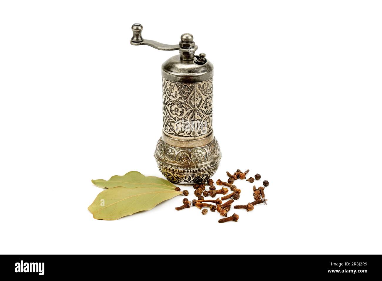 Manual grinder, clove spice and laurel isolated on white background ...