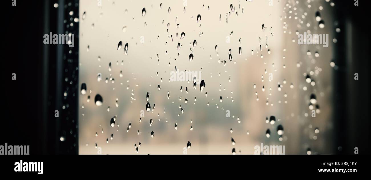 Rain drop on window glass of coffee shop and blurry city life ...