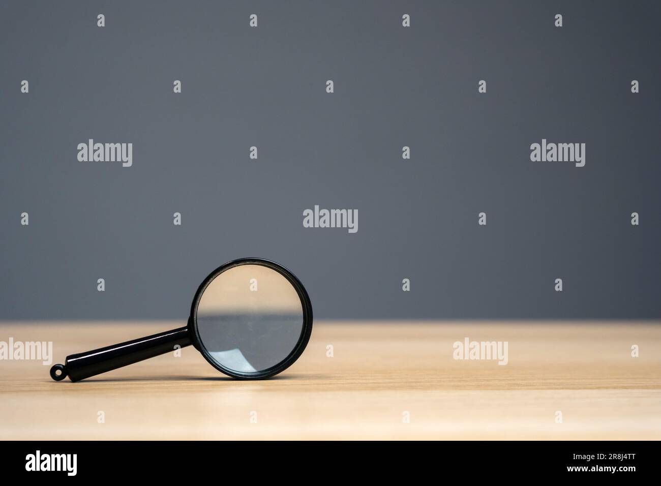 Magnifying glass on a grey background. Search and analysis, analytics ...