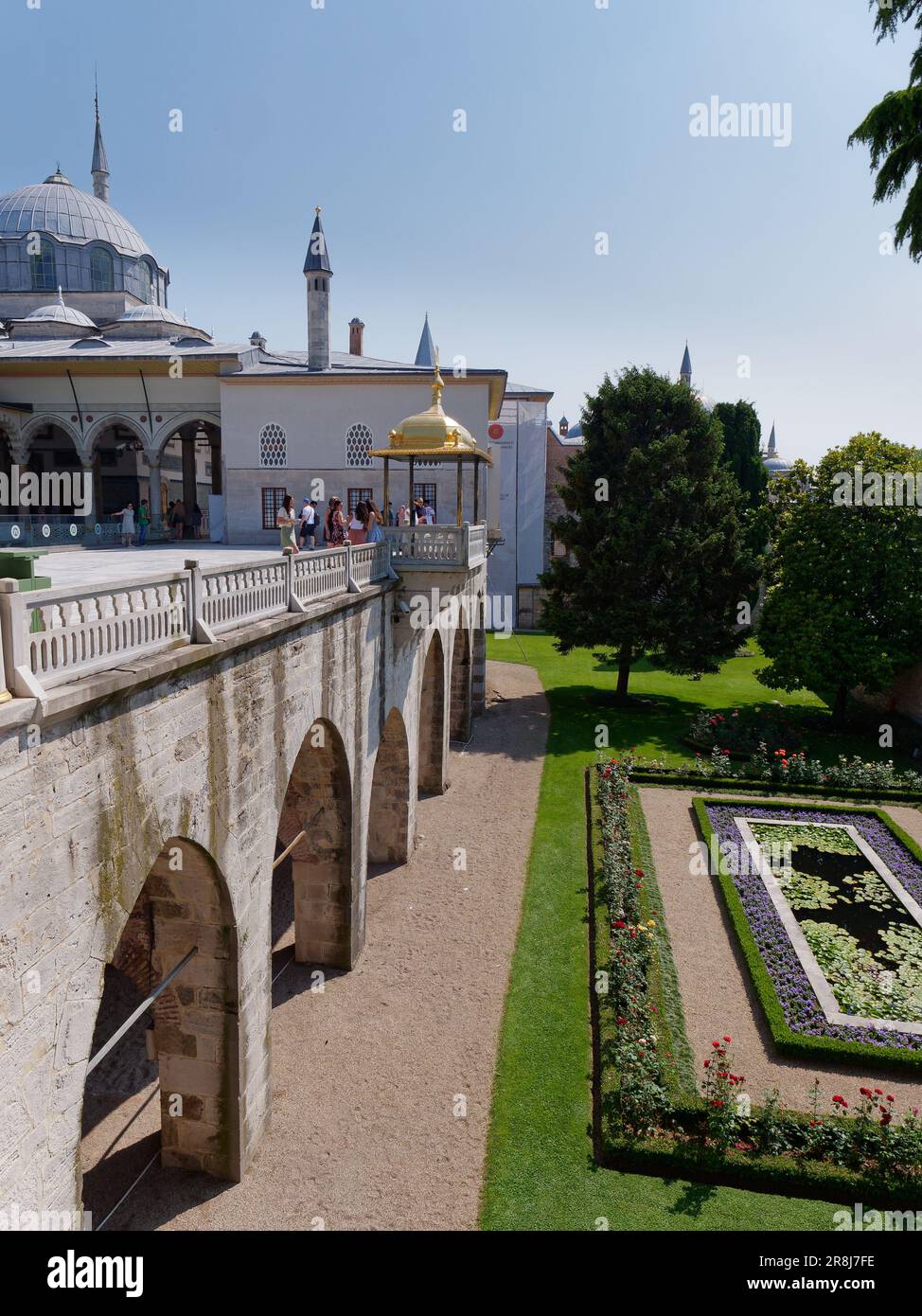 Elegant buildings and garden with a pond in the grounds of the Topkapi ...