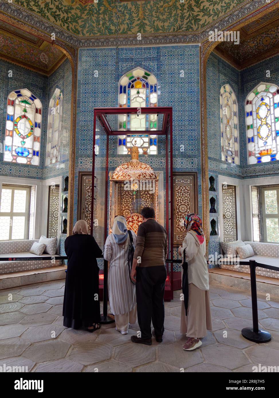 Tourists inside an Elegant room with stained glass windows inside the ...