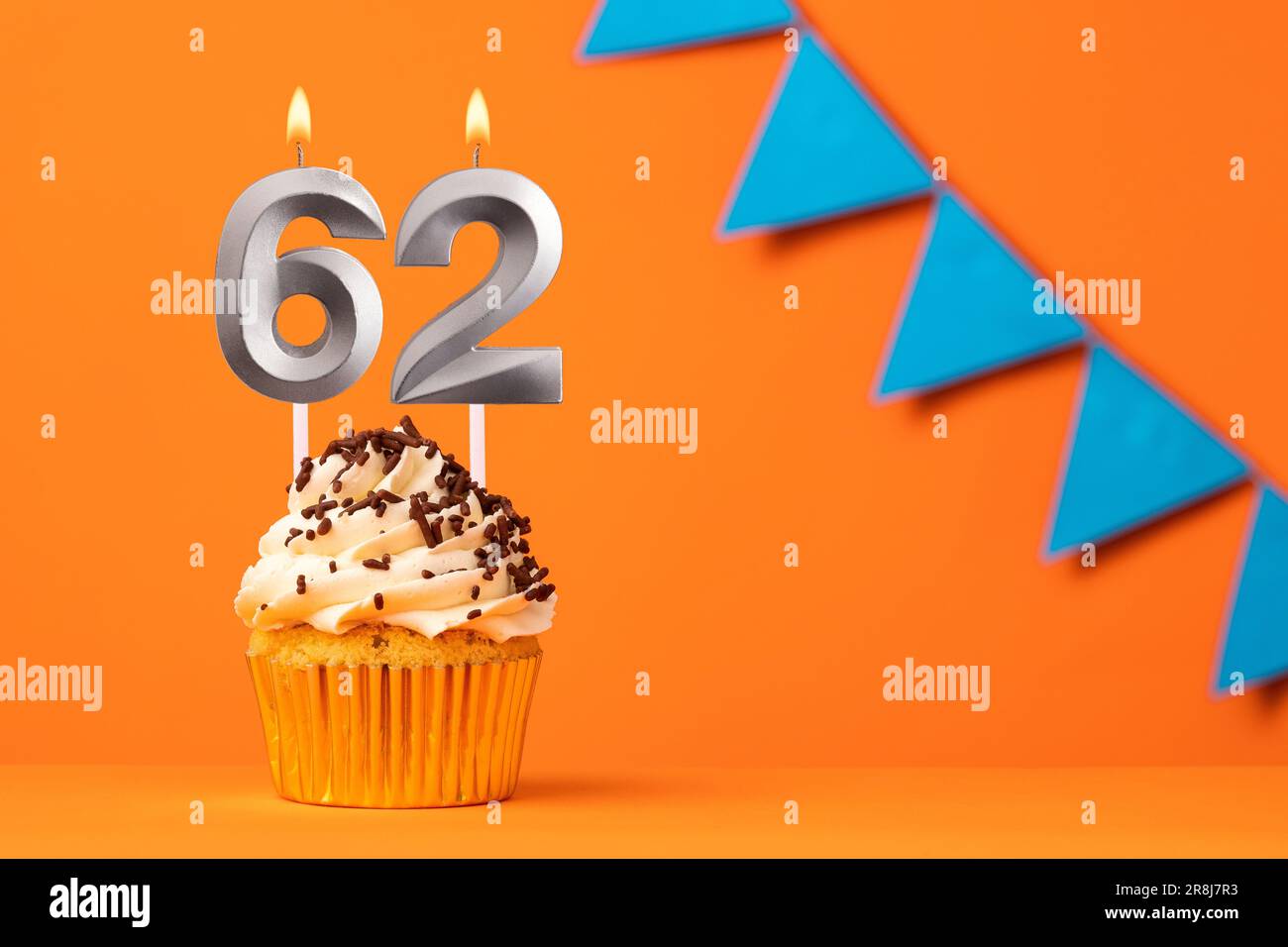 Birthday cake with candle number 62 - Orange background Stock Photo - Alamy