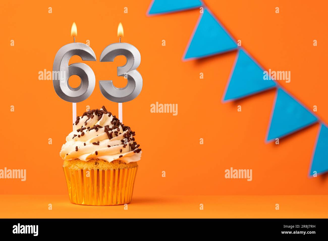 Candle number 63 - Cake birthday in orange background Stock Photo - Alamy