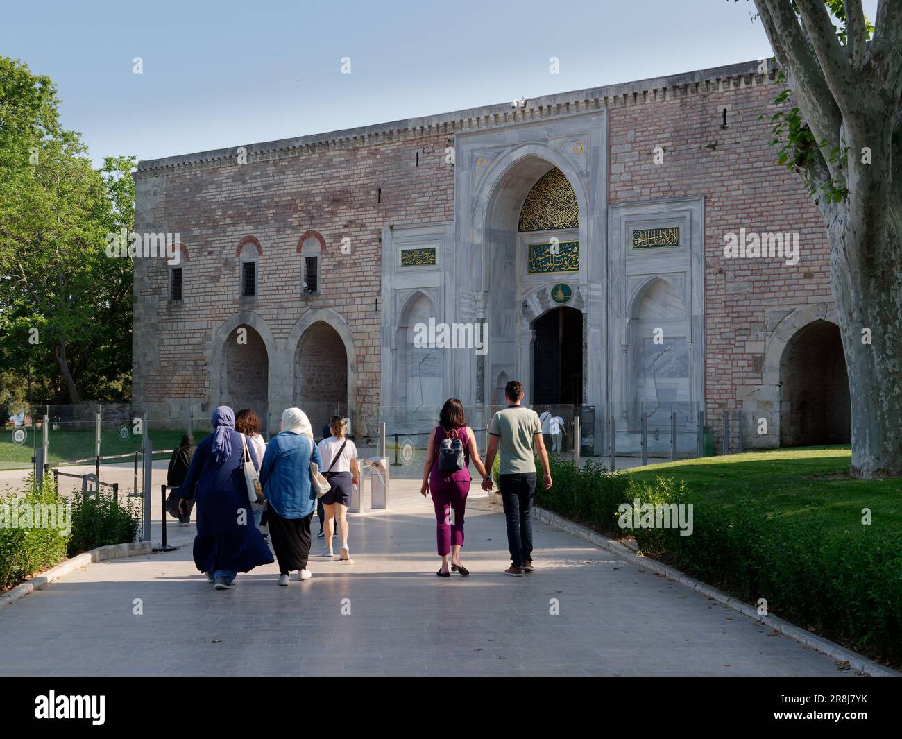 Visitors exiting the Imperial Gate, the outer most gate of the Topkapi ...
