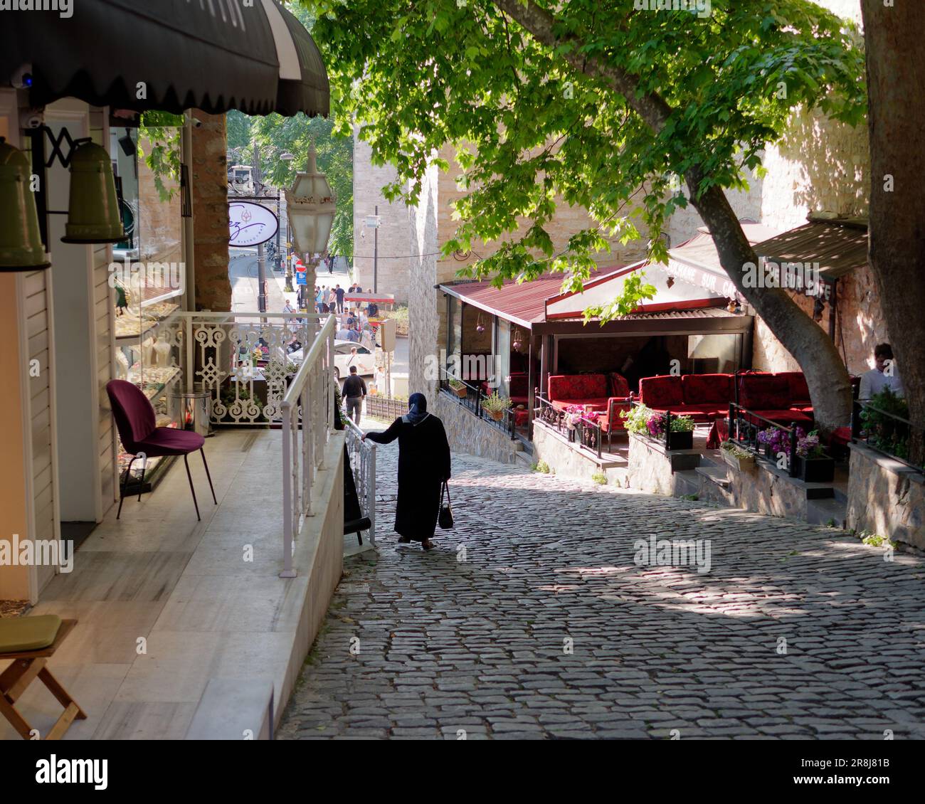 Elderly label in traditional muslim clotthes gigerly walks down a ...