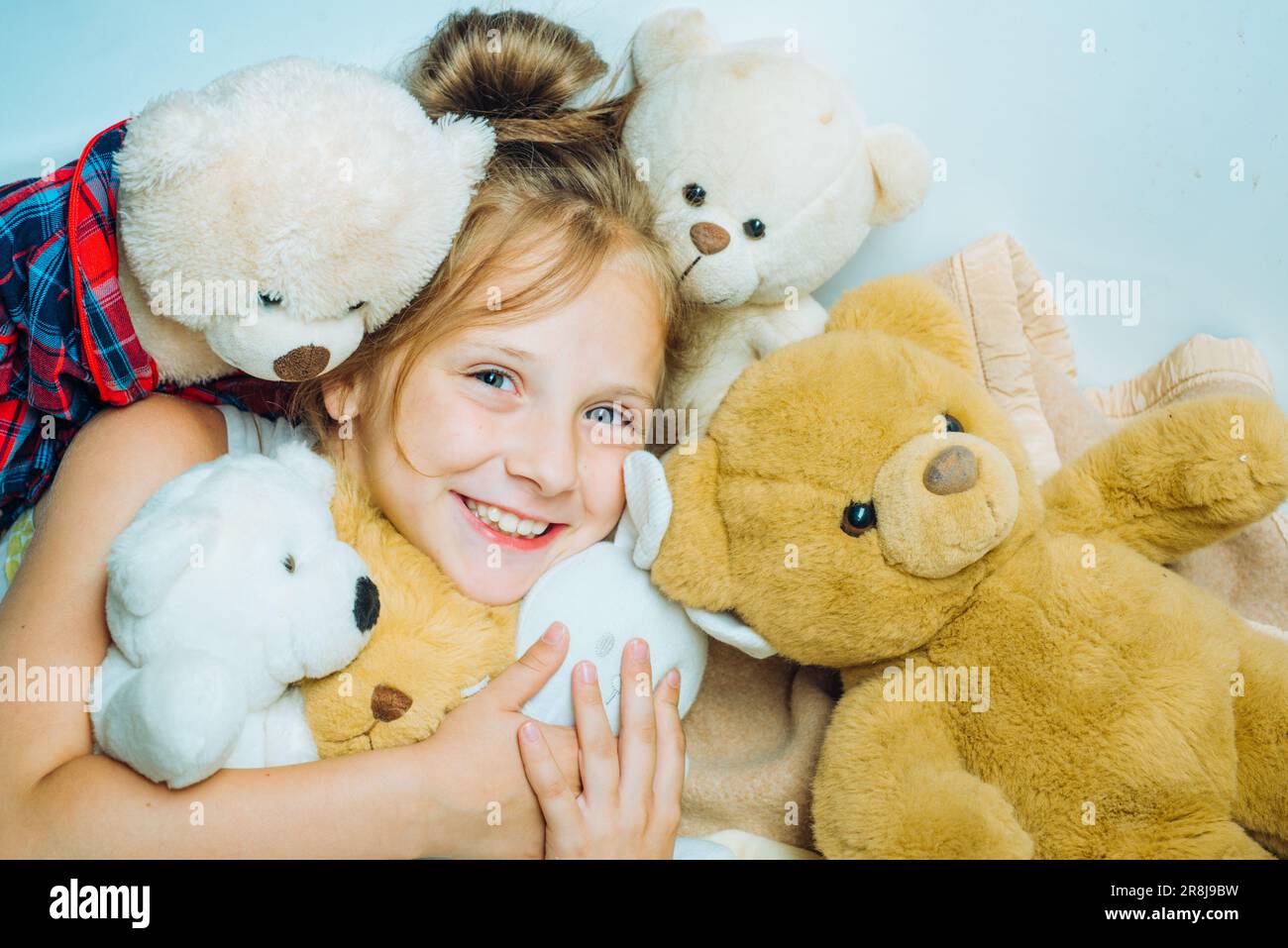 Child hugging teddy bear. Toys dream. Kid girl dreams near tiys teddy ...