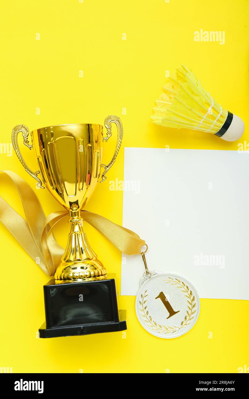 Blank card with gold cup, first place medal and badminton equipment on ...