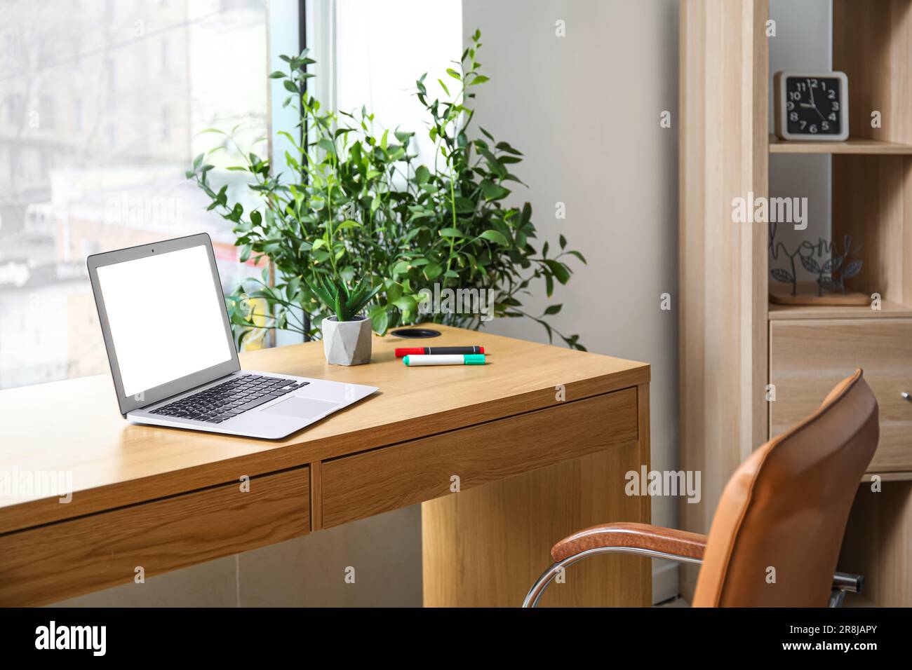Modern workplace with laptop near window in office Stock Photo - Alamy