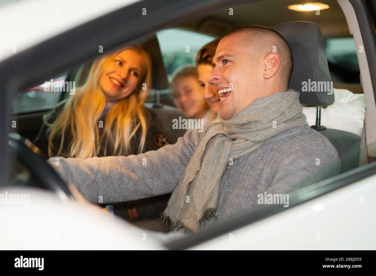 Happy father driving a car driving his family to holiday fair Stock ...