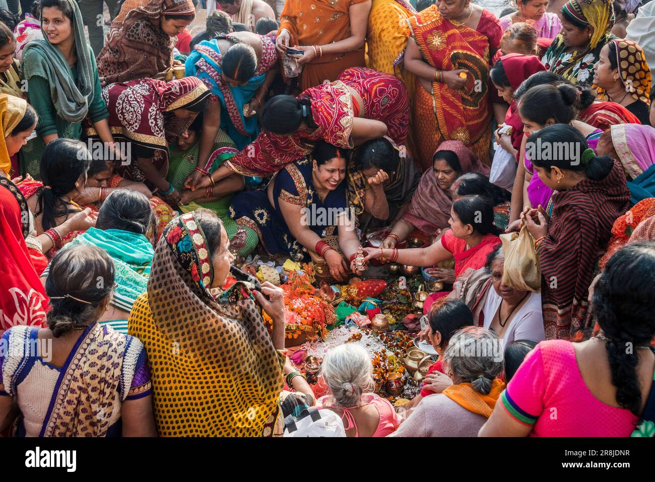 A group of women pilgrims perform a ritual on the ghats of Varanasi ...