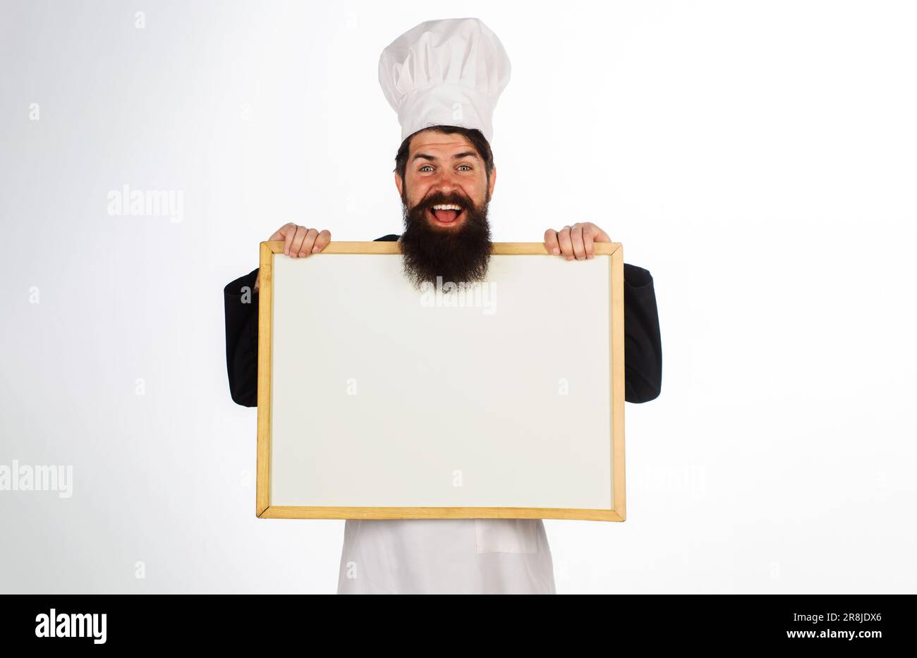 Smiling male chef with empty whiteboard. Cook showing billboard with ...