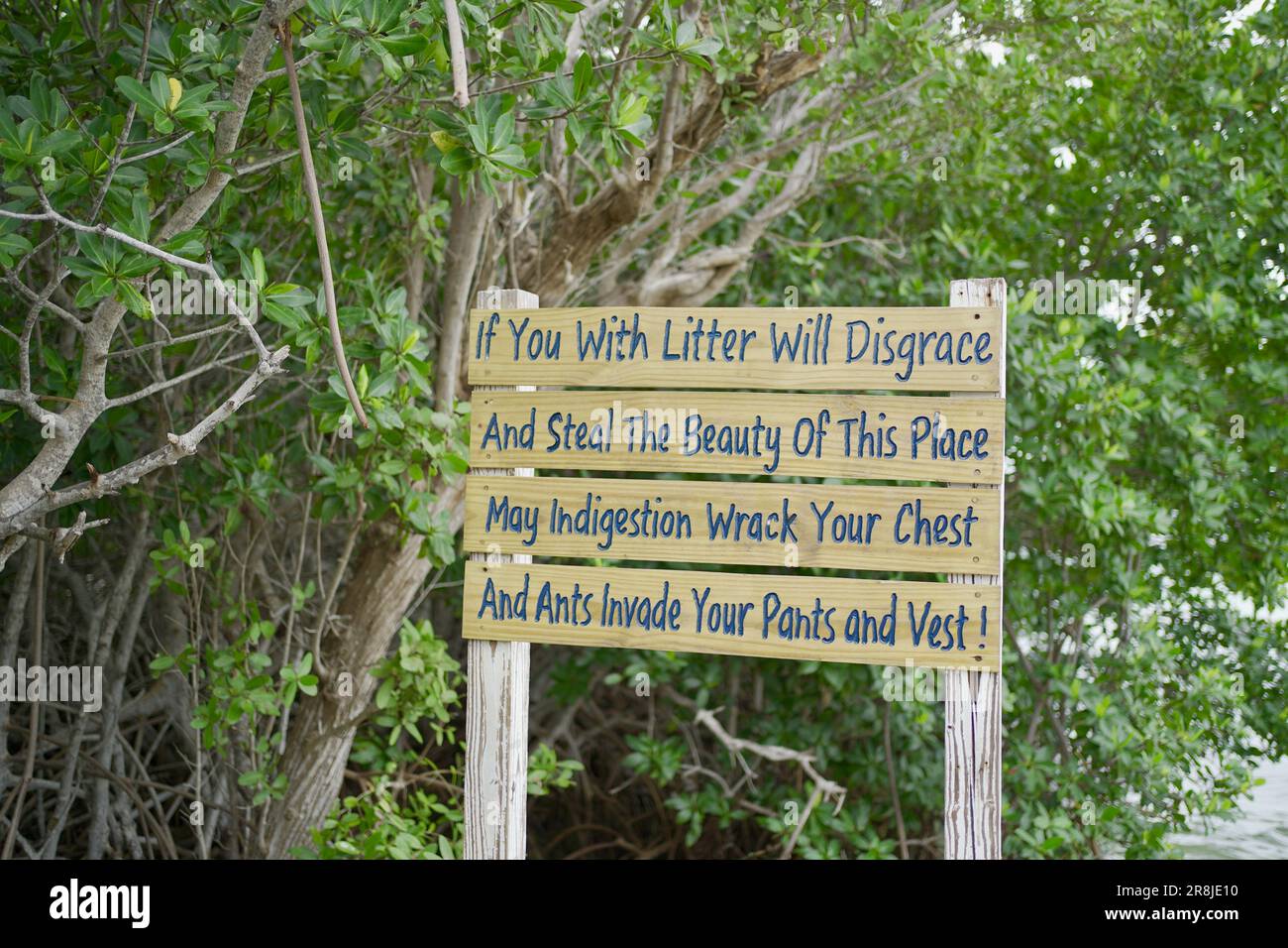 A rustic wooden sign post warning against littering in the Florida Keys ...