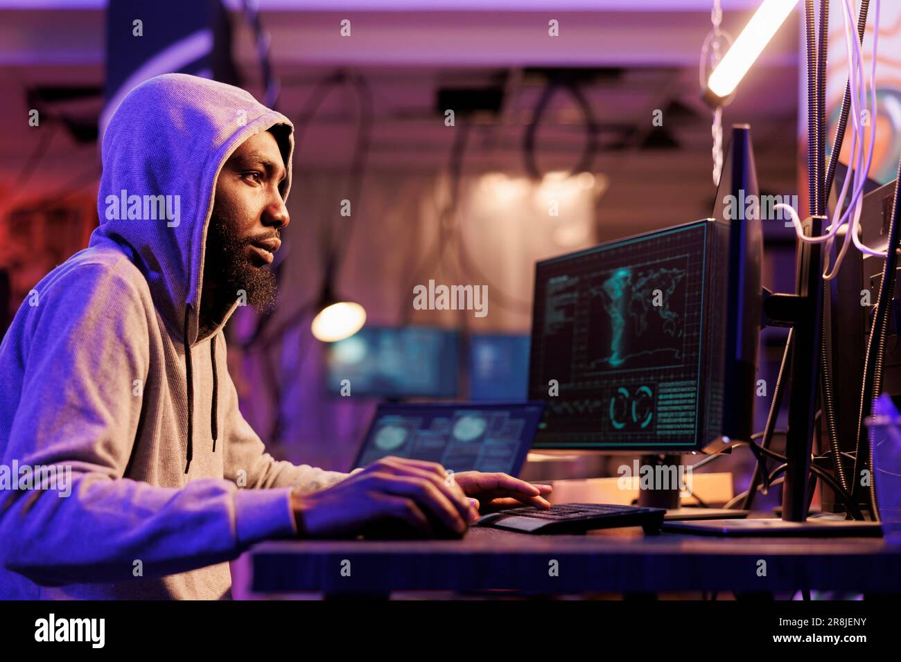 Hacker In Hood Breaching Company Cybersecurity System On Computer