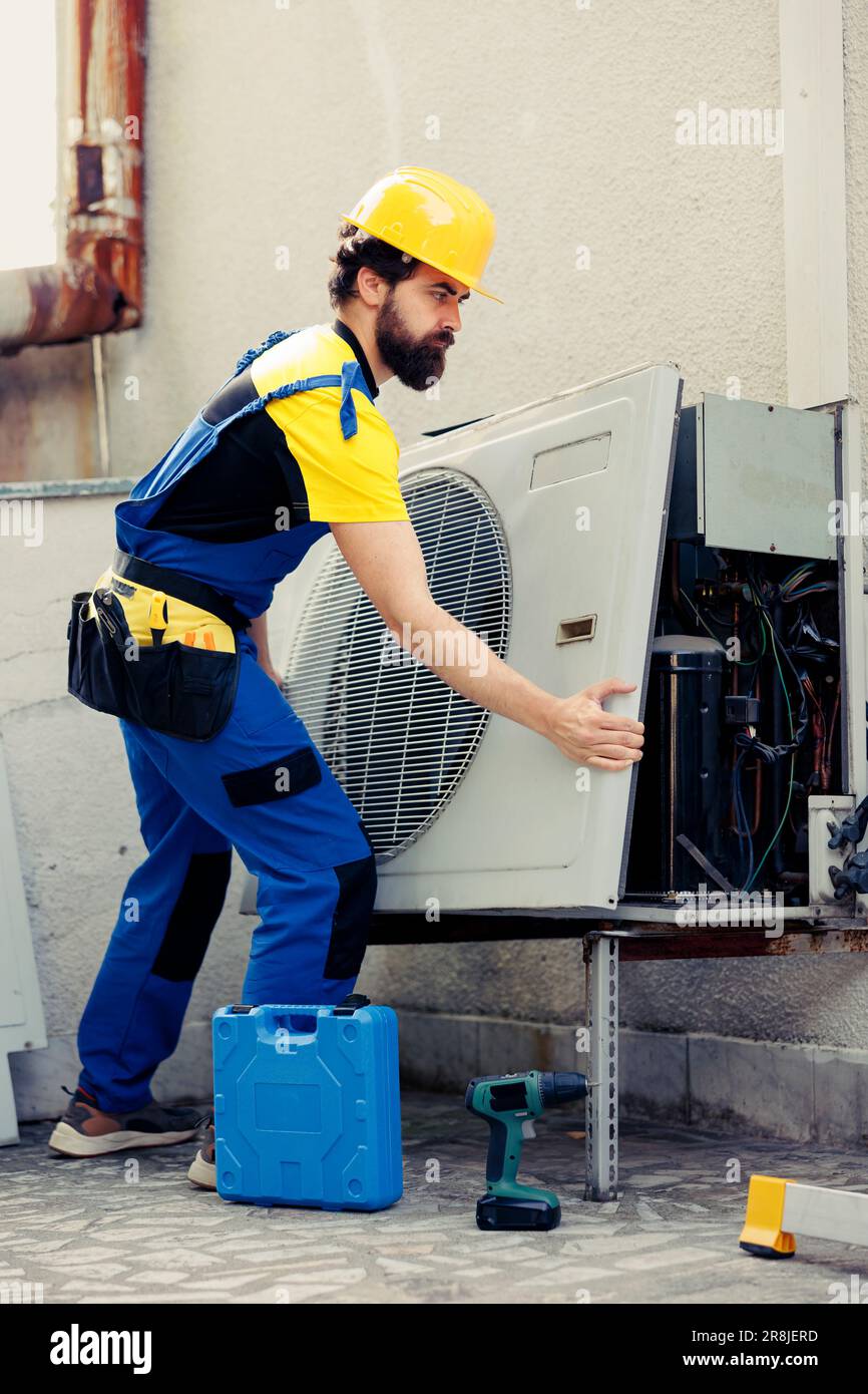 Licensed expert starting work on out of order air conditioner, using ...