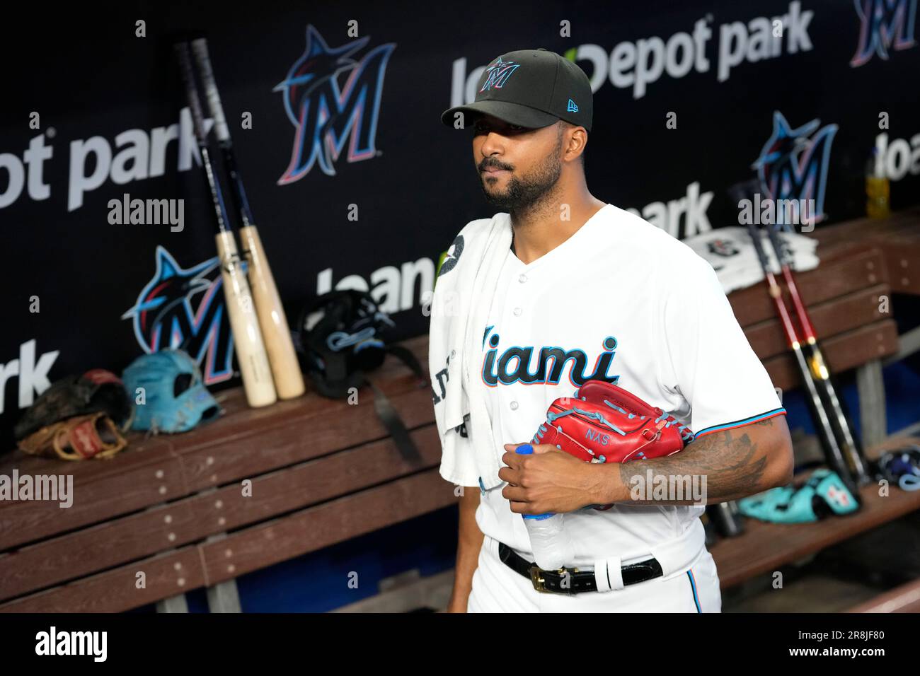 Miami Marlins starting pitcher Sandy Alcantara walks in the dugout ...
