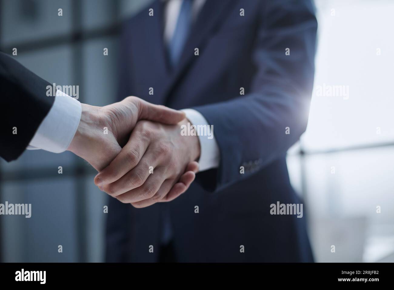 businessmen meeting and handshake in front of business center buildings ...