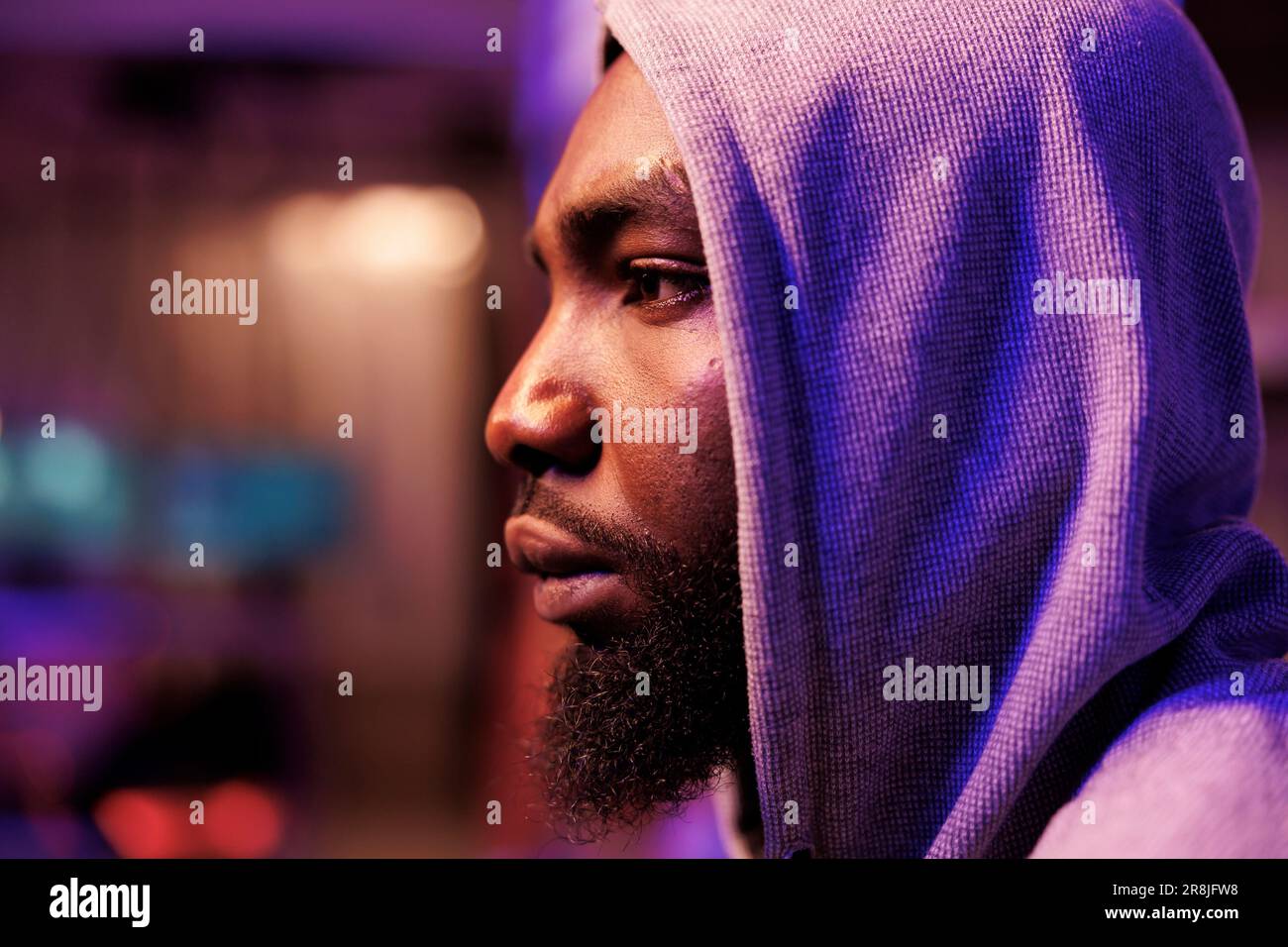 Concentrated african american man in hood breaking into computer system ... Concentrated african american man in hood breaking into computer system ...