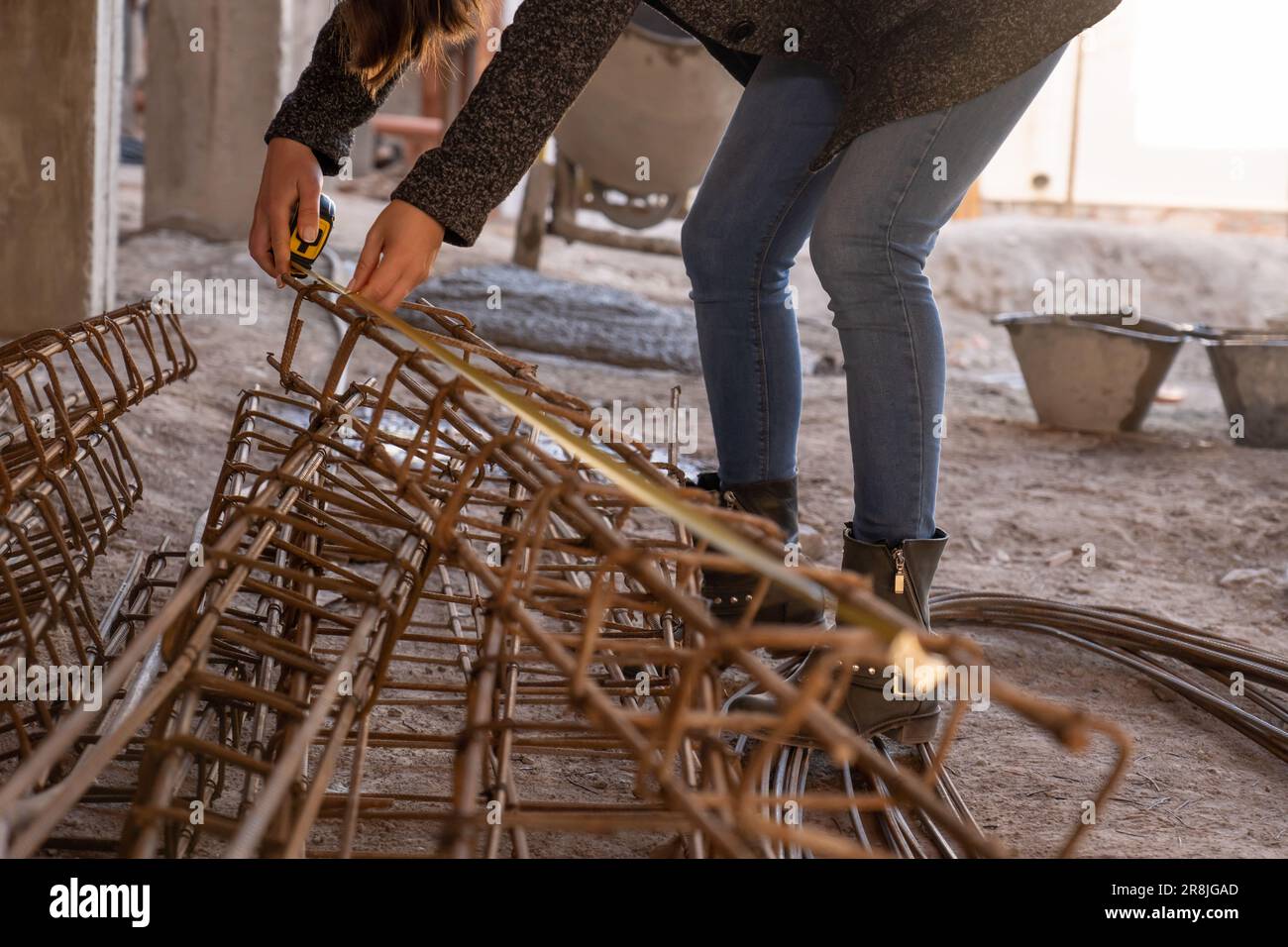 Unrecognizable person working on construction site, measuring chaining ...