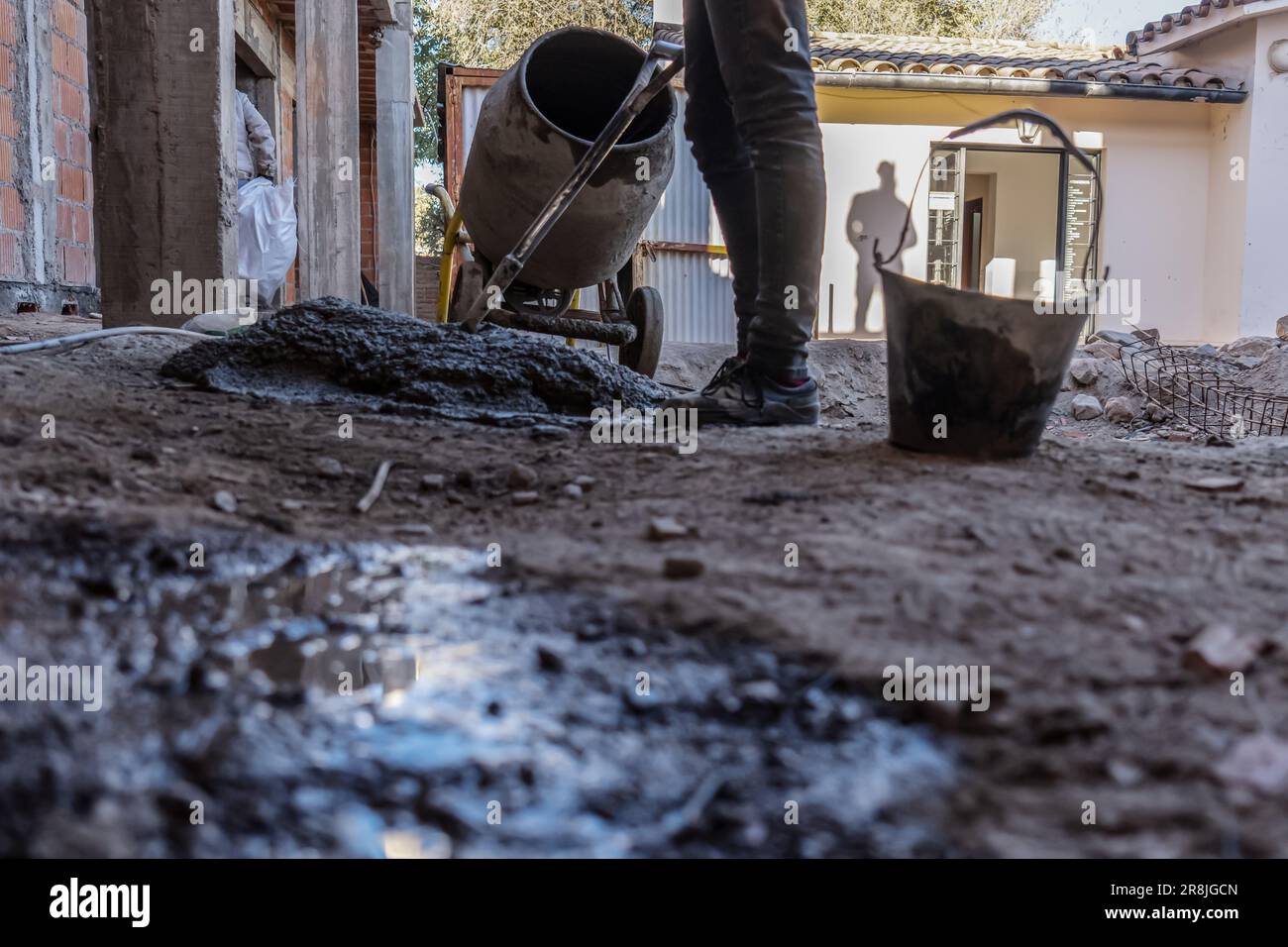 Construction worker prepares cement at a construction site. Close-up of ...