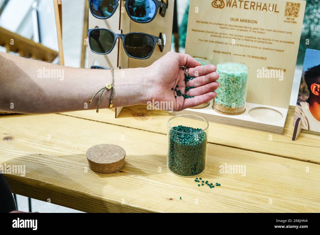 Portsmouth, UK. 20th June, 2023. A person's hand seen pouring recycled ...