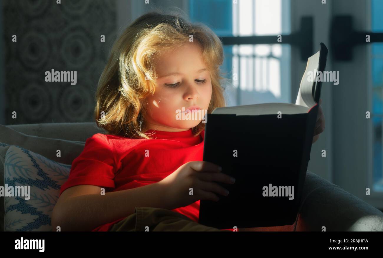Portrait of cute blonde child reading interesting kids book story ...