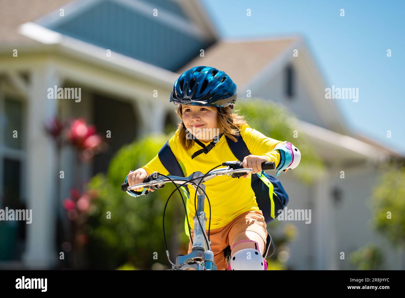 Kid riding bike in a helmet. Child riding bike in protective helmet ...